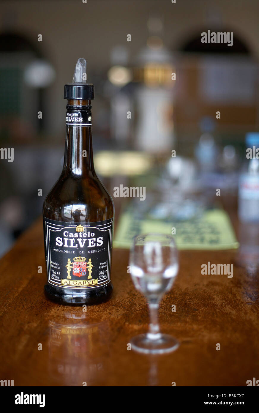 A bottle of traditional local liqueur Medronho in a bar in Alte ...