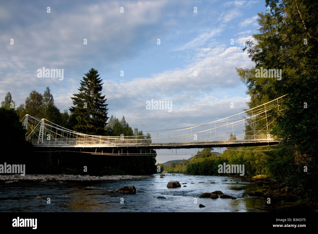 A suspension bridge over the river Dee, near to Ballater in Scotland ...