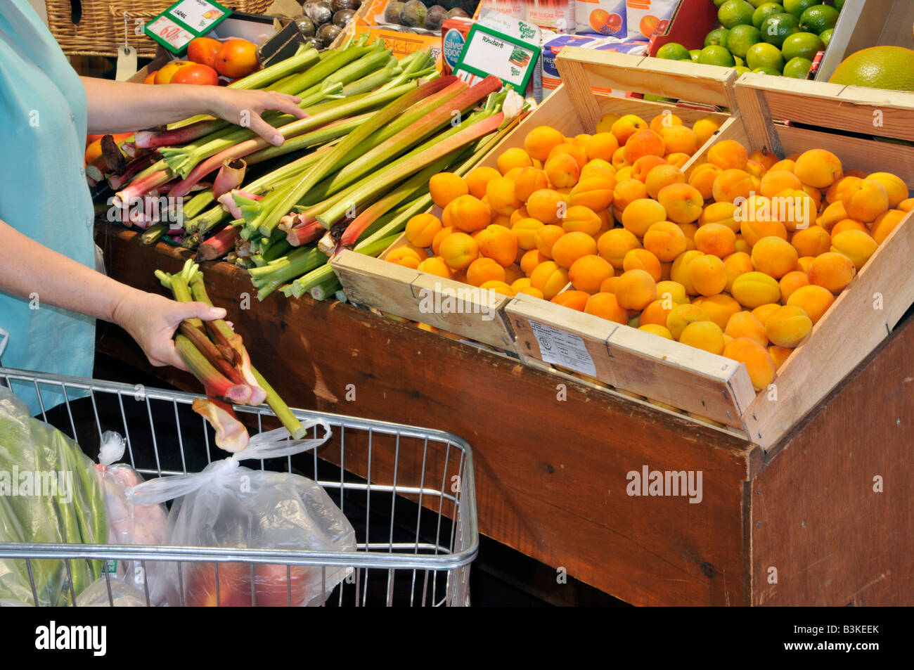 Interior of Calcott Hall retail farm shop produce on display woman ...