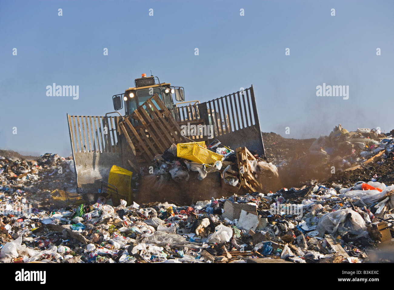 Tractor compactor/dozer pushing garbage at landfill Stock Photo - Alamy
