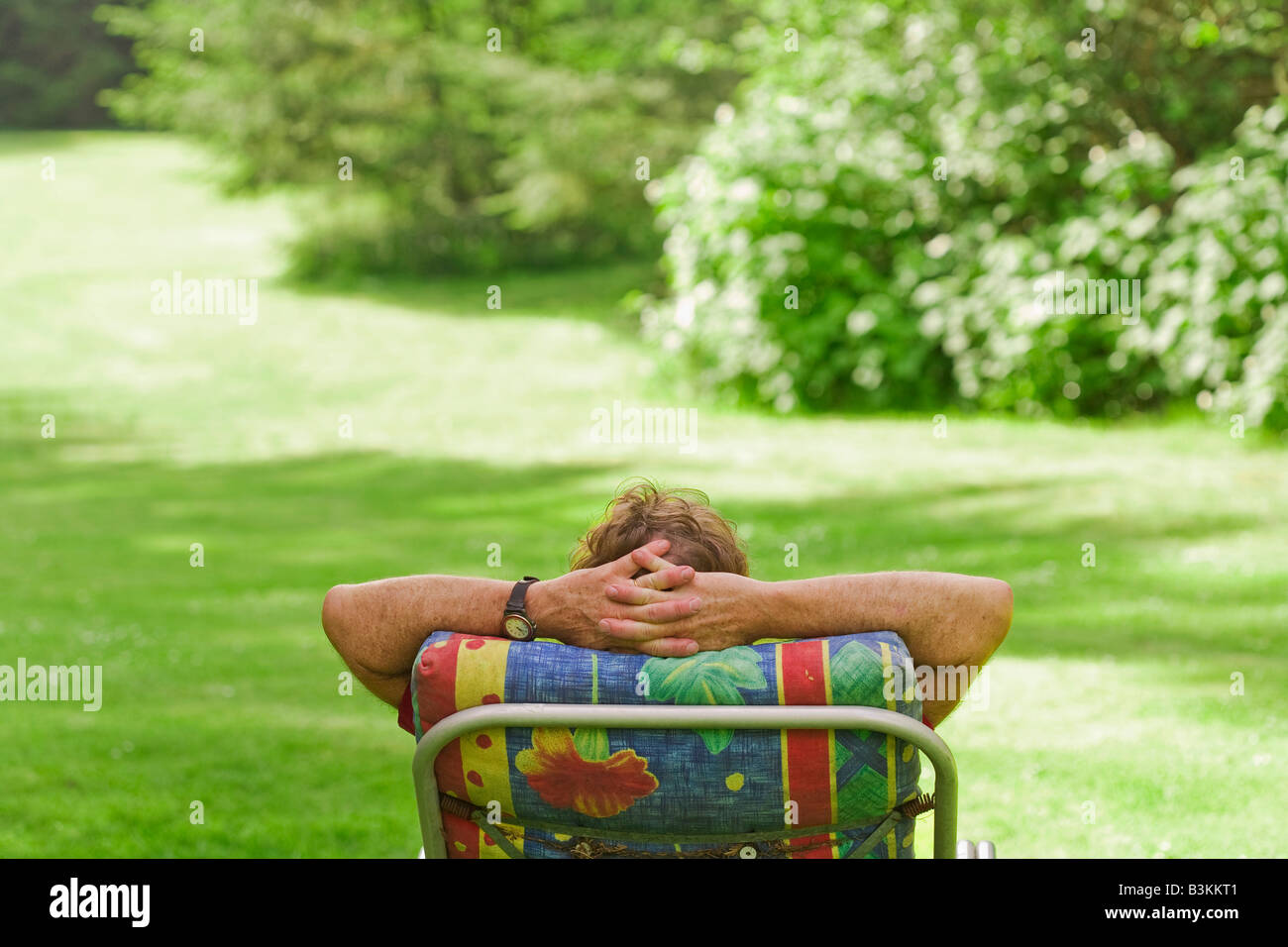 Man relaxing in lounge chair Stock Photo - Alamy