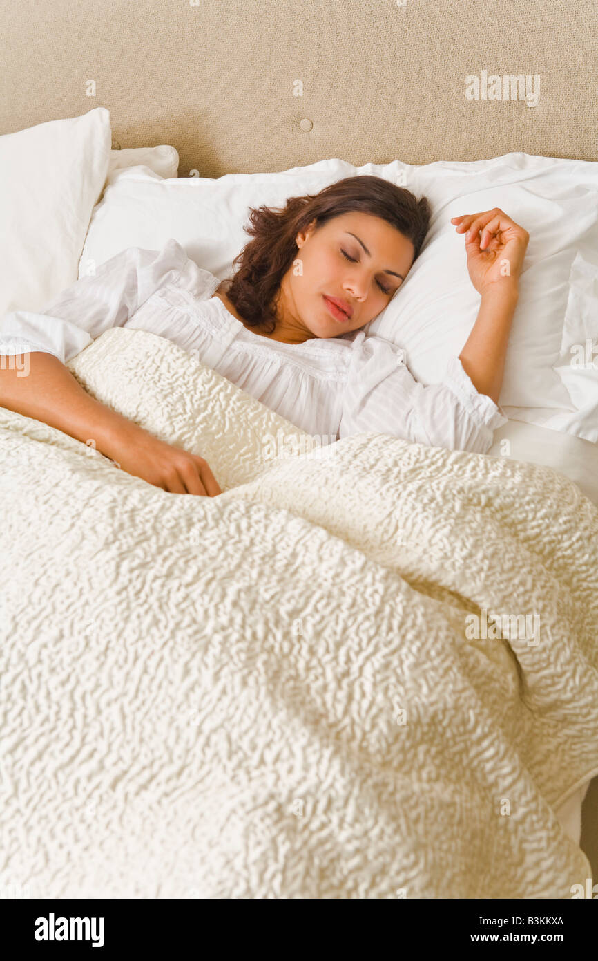 Woman sleeping in comfortable bed Stock Photo - Alamy