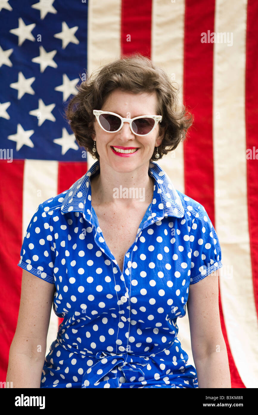 Patriotic woman posing with American flag Stock Photo - Alamy