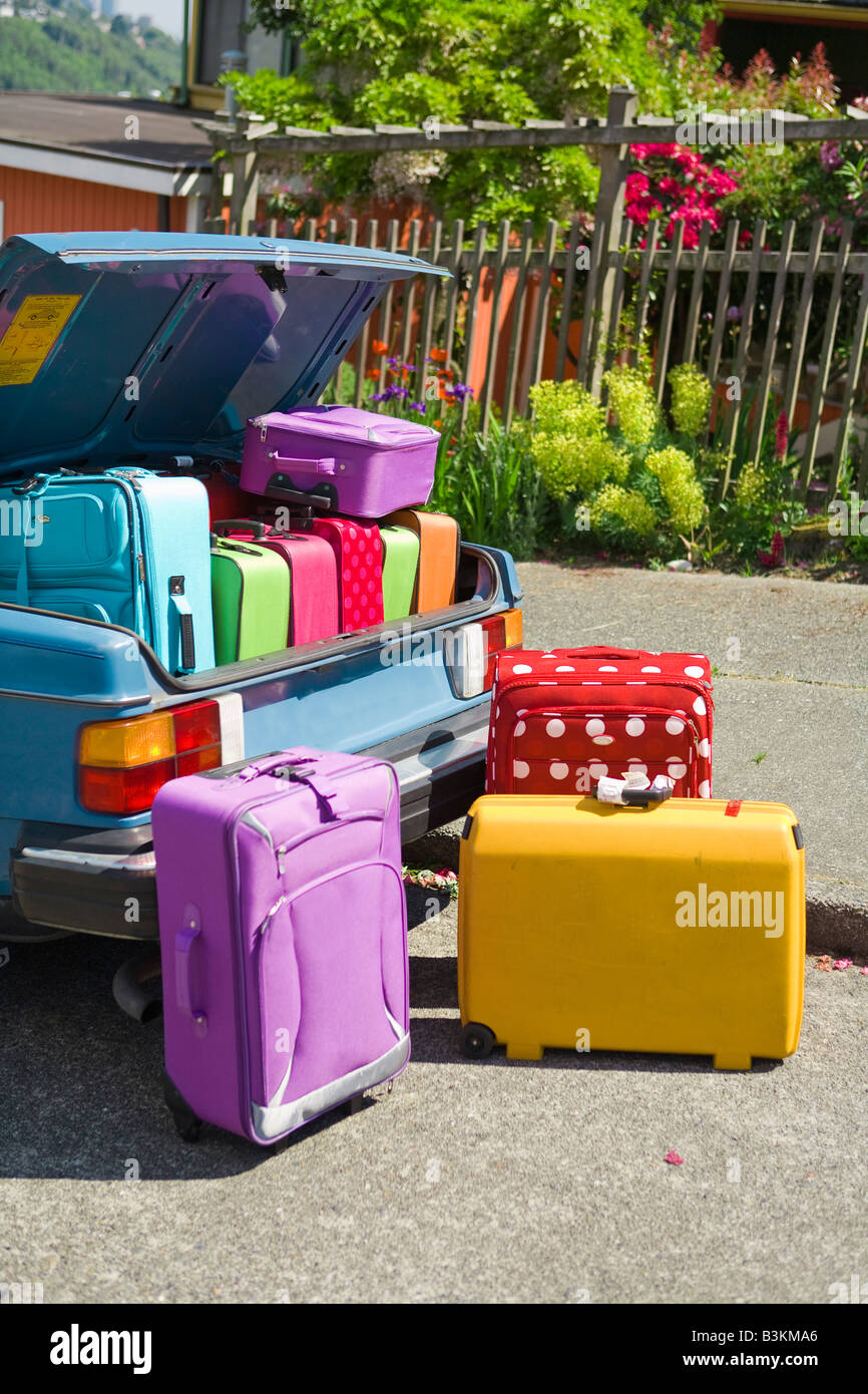Car trunk loaded with colorful suitcases Stock Photo - Alamy