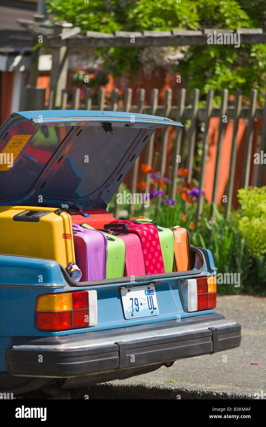 Car trunk loaded with colorful suitcases Stock Photo - Alamy