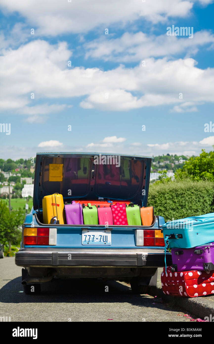 Car trunk loaded with colorful suitcases Stock Photo - Alamy