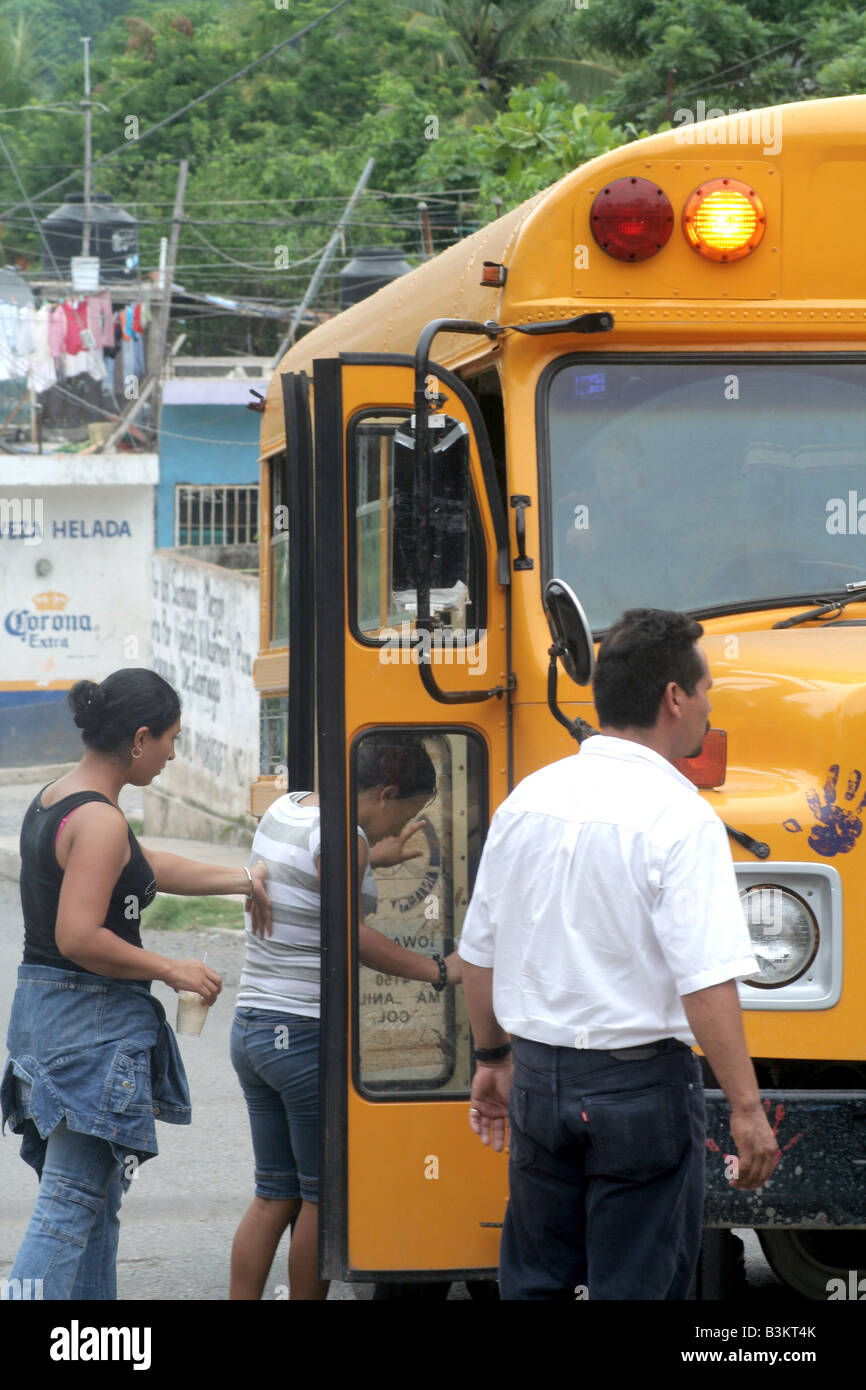 Kids getting on a school bus with a guard watching in Mexico Stock ...