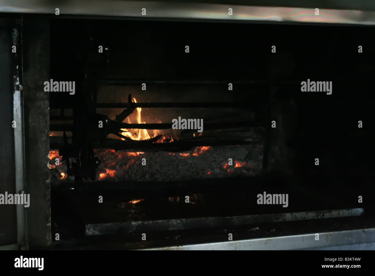 A dark fire pit for roasting chickens Stock Photo - Alamy