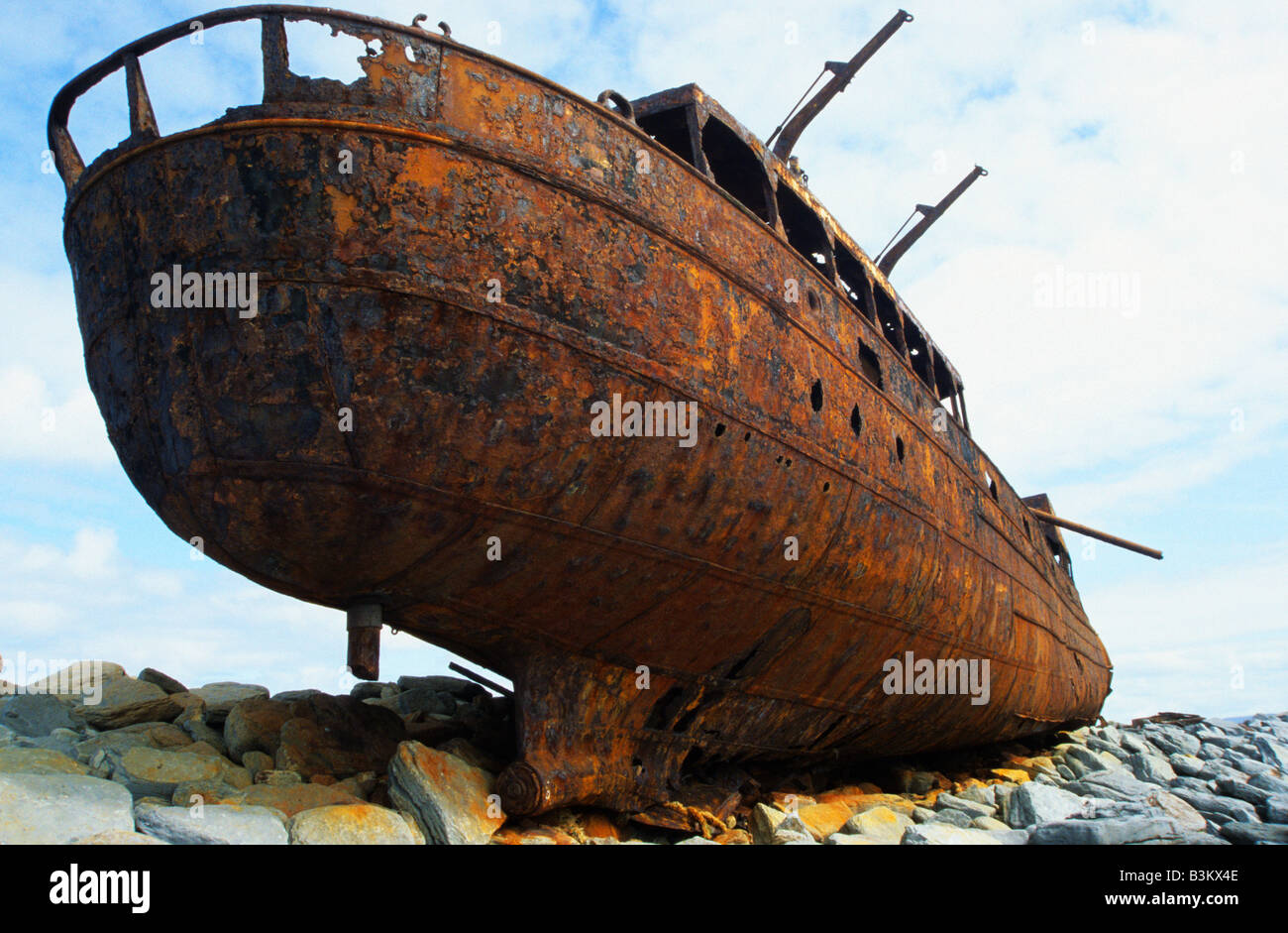 A rusty shipwreck of the M.V. Plassey on the shores of Inisheer in the ...