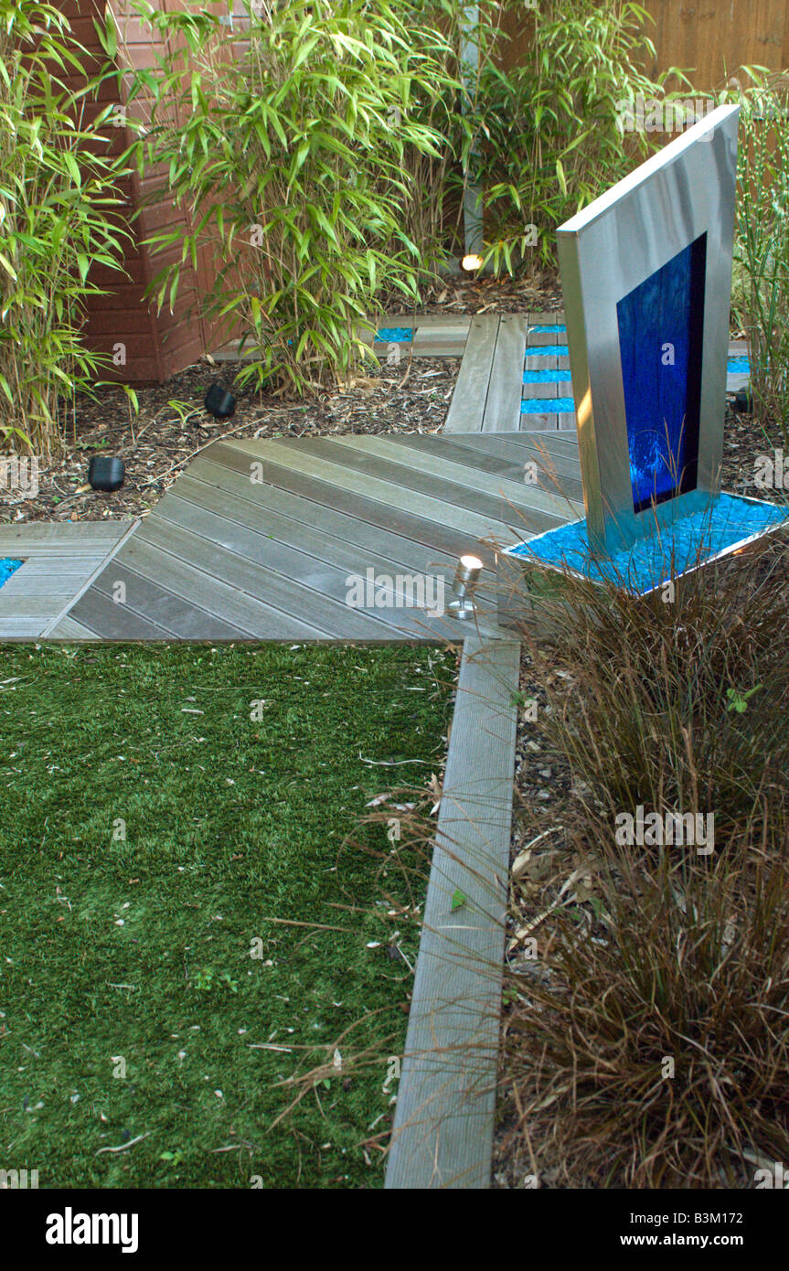 modern landscaped garden with water feature and astro-turf lawn and ...