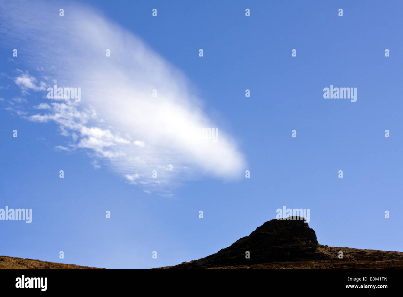 A cloud pointing down towards Housey Crags in the cheviot hills, with a ...