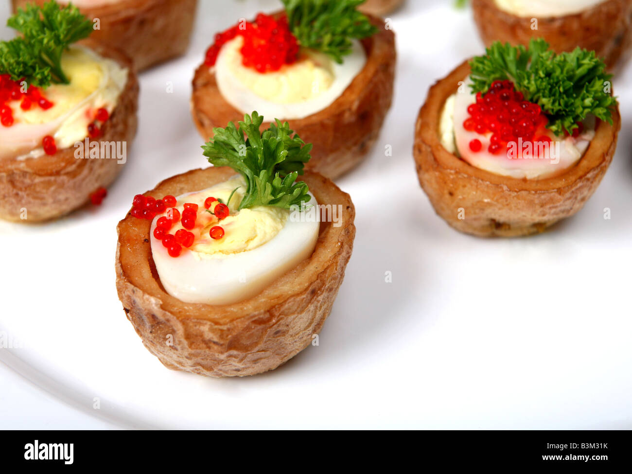 A plate of quails egg canapes the eggs are in tiny baked jacket ...
