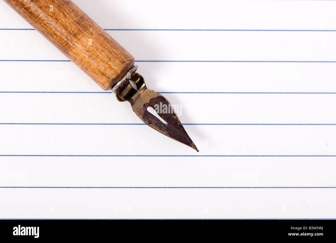 An old book that is open with a calligraphy pen on top Stock Photo - Alamy
