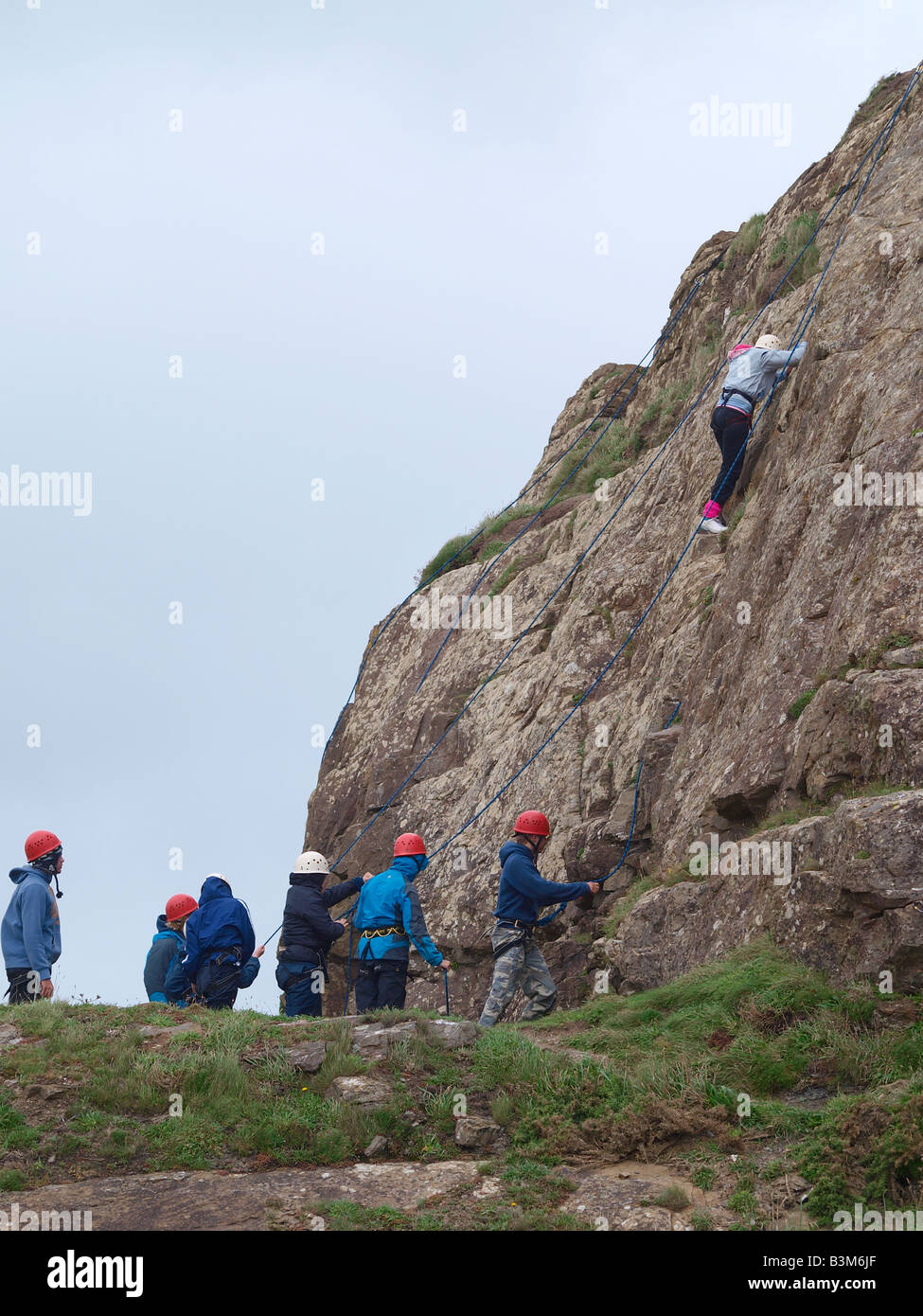Group of teenagers rock climbing Stock Photo - Alamy