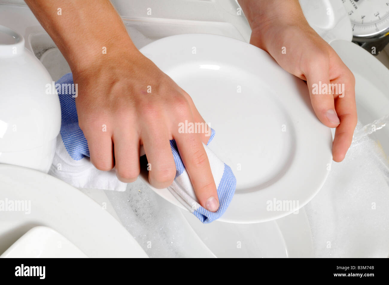 Man drying crockery hi-res stock photography and images - Alamy