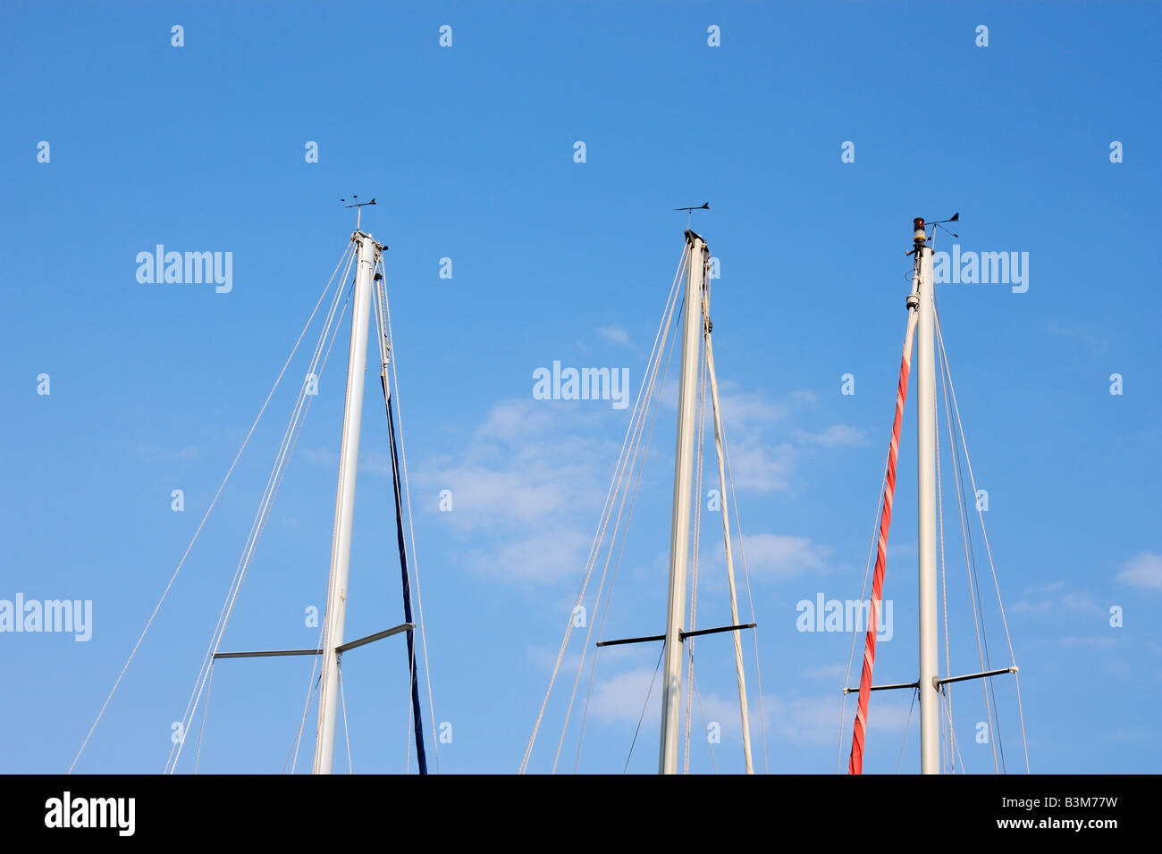 The upper parts of the masts of three sailing boats Stock Photo - Alamy