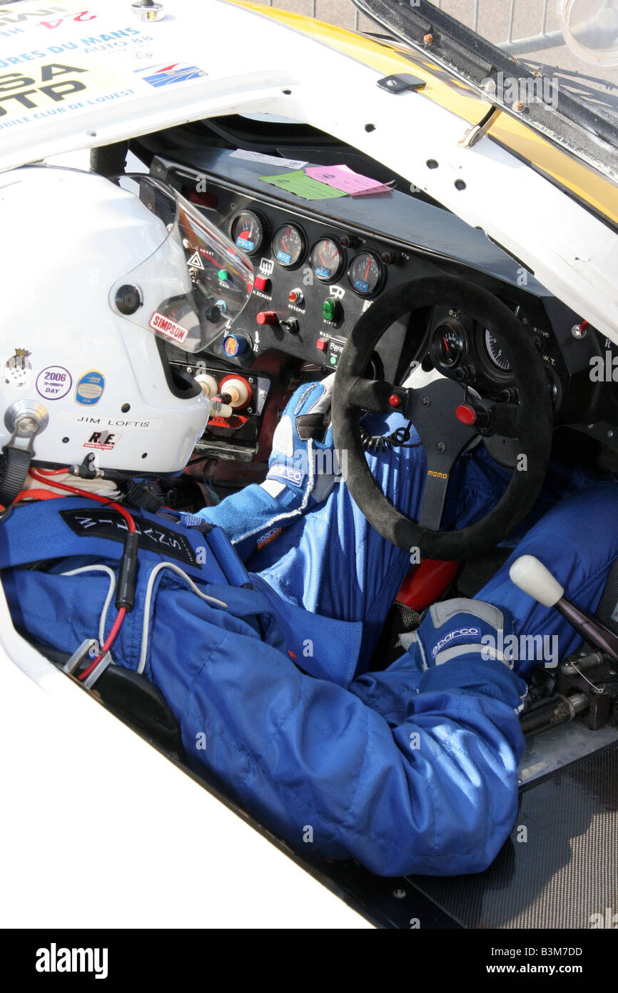 racing driver in a white helmet in his car at the start of a classic ...
