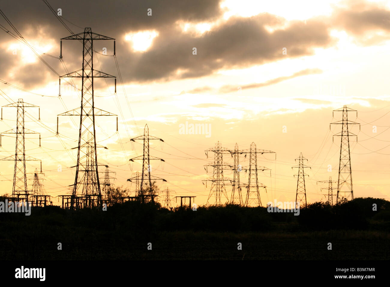 Electricity pylons at sunset Stock Photo - Alamy