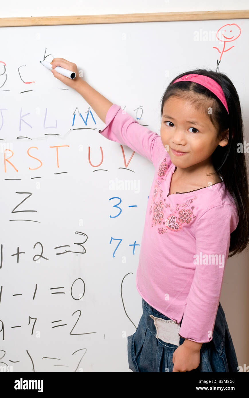 A young girl learning her numbers and letters Stock Photo - Alamy