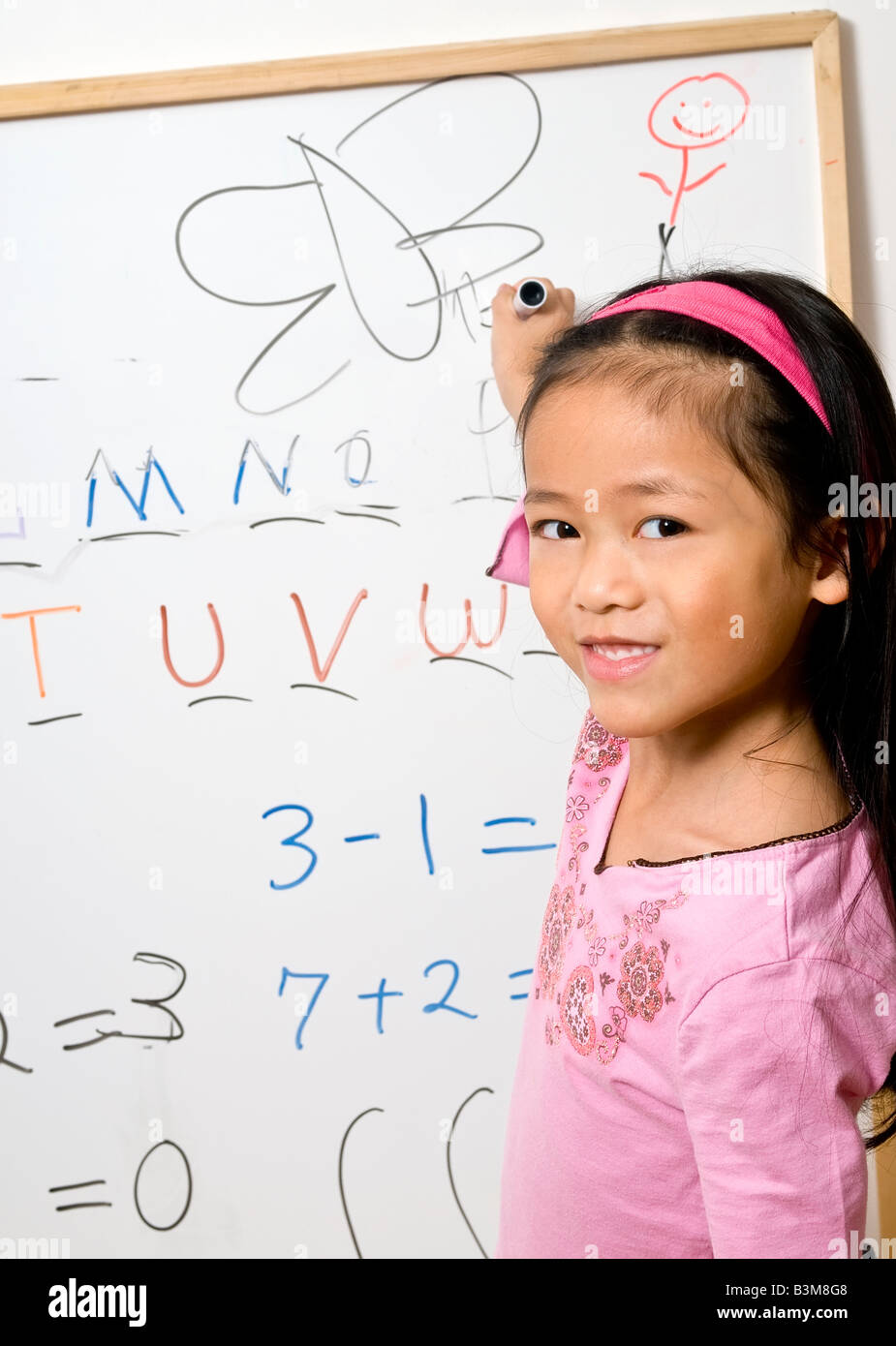 A young girl works on her numbers and letters Stock Photo - Alamy
