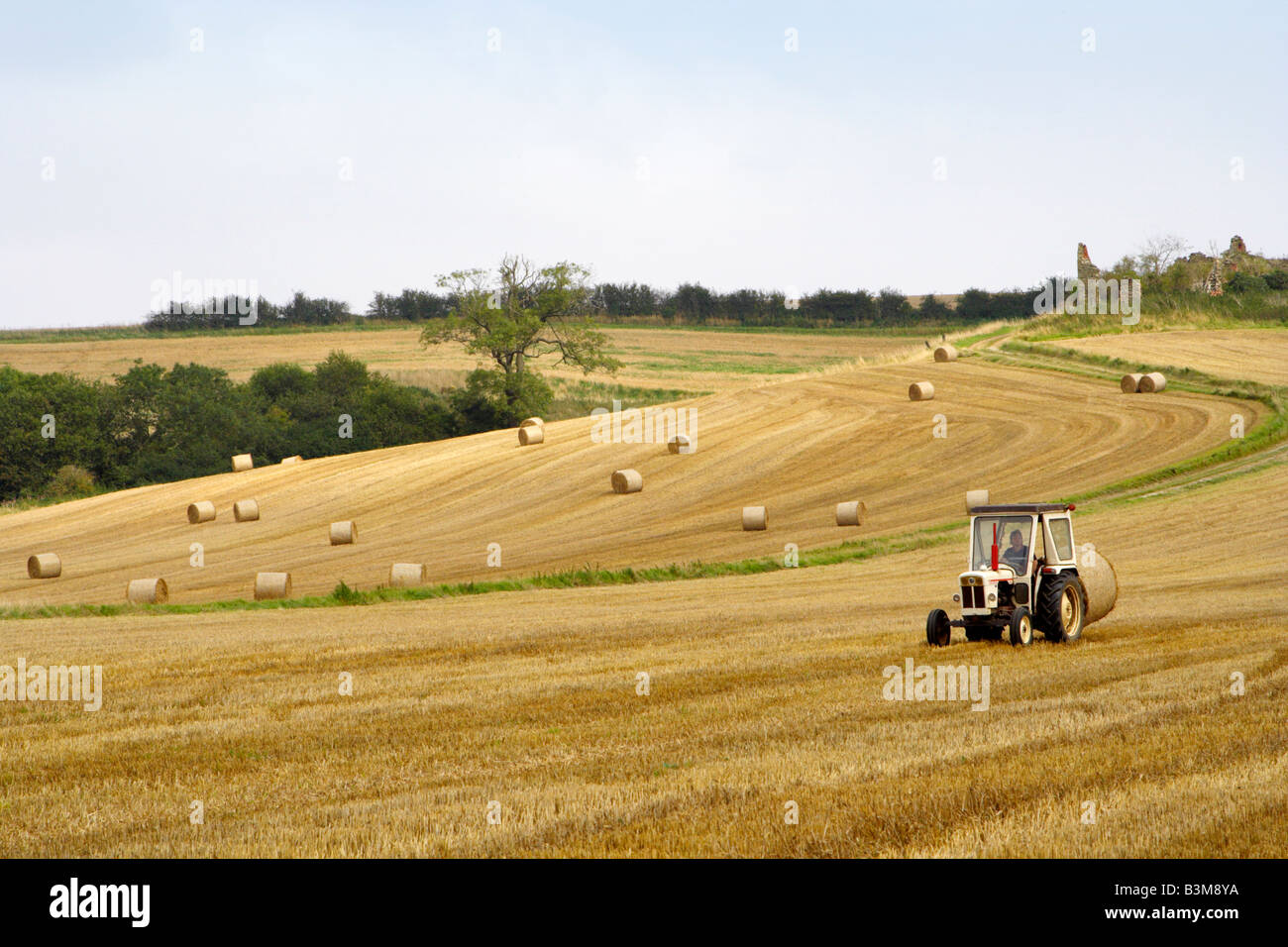tractor gathering hay bales Stock Photo - Alamy