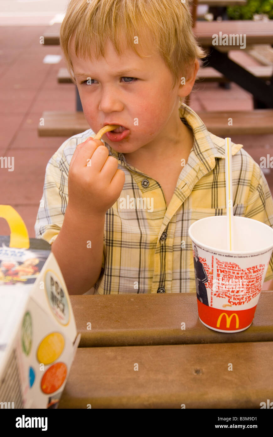Five year old boy eating Happy Meal at Mcdonald's Stock Photo - Alamy