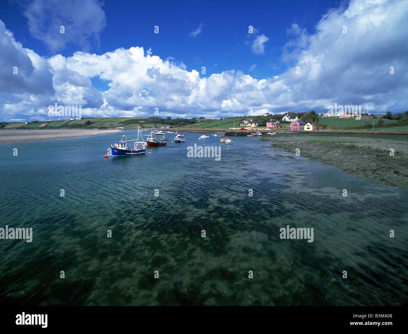 brightly painted fishing boats anchored in an atlantic sea inlet on ...