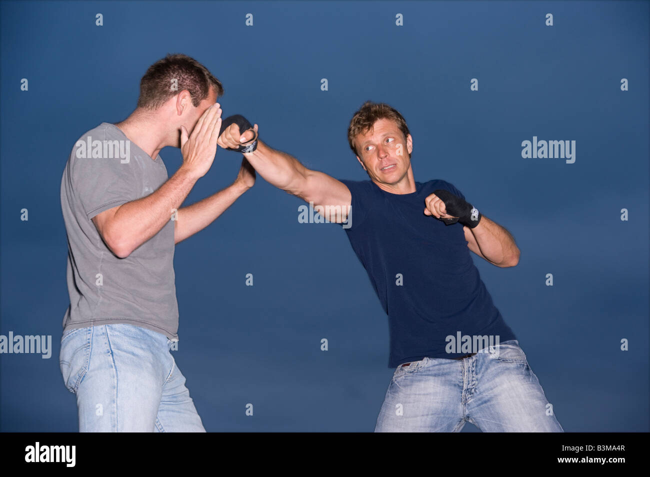 Street fighter boxing trainspar one and two men outside evening Stock ...