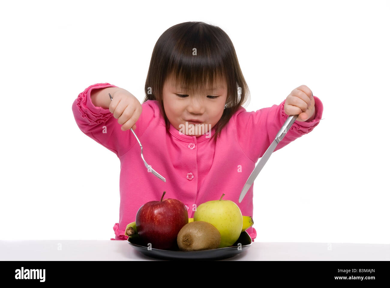 A young girl with a plate full of fruits Stock Photo - Alamy