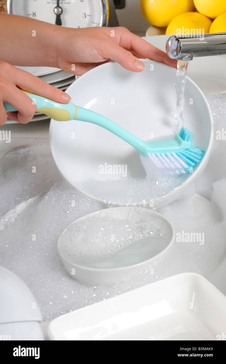 Woman sink washing up cutlery hi-res stock photography and images - Alamy