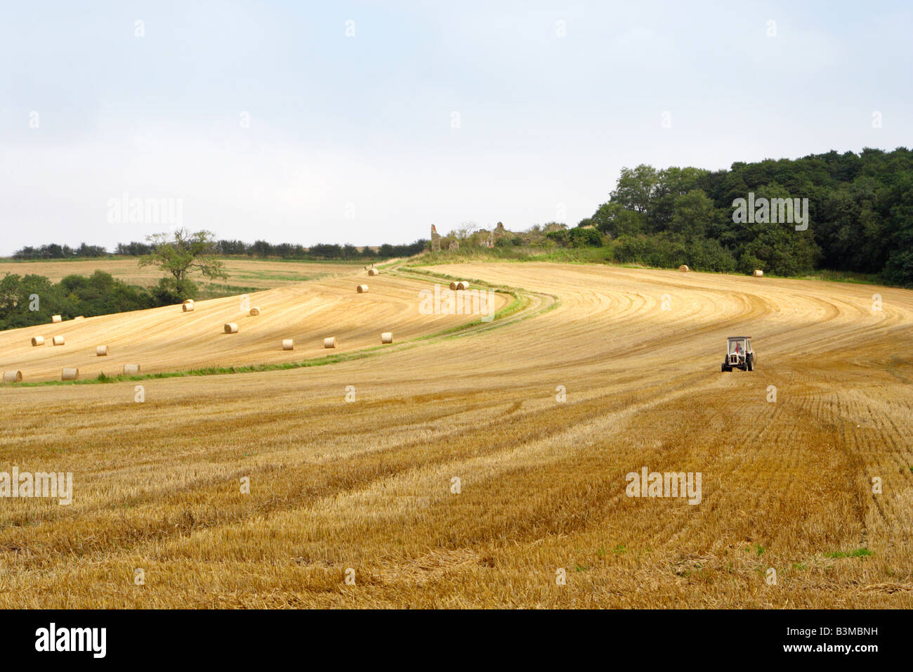 tractor gathering hay bales Stock Photo - Alamy