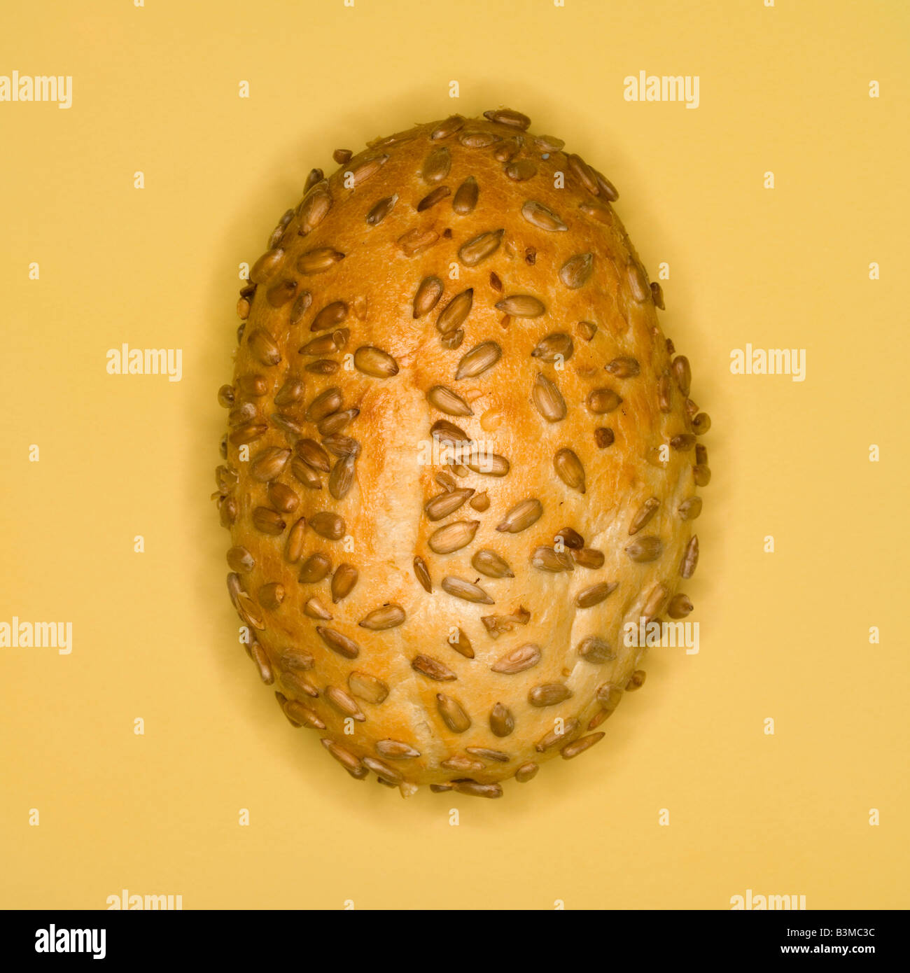 Bread roll topped with sunflower seeds, elevated view Stock Photo - Alamy
