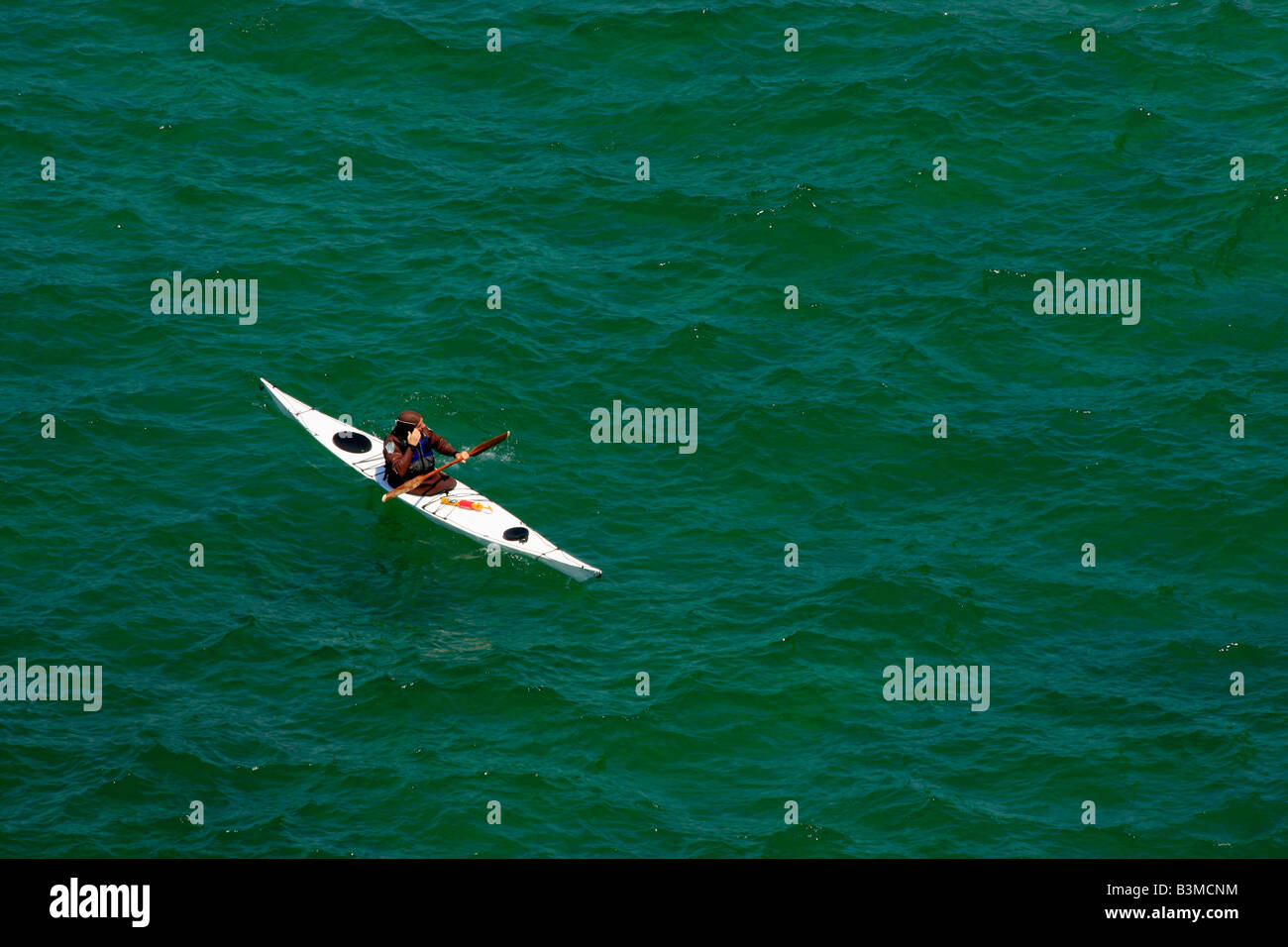 Lake Superior Michigan in USA US American a man in a kayak paddling ...