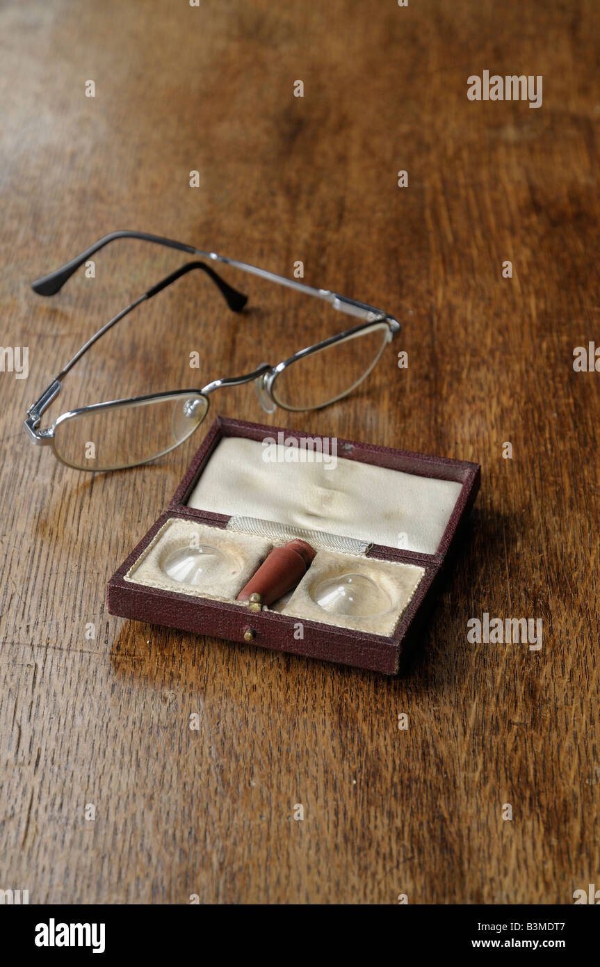 Some old spectacles and old contact lenses, in the original box on a ...