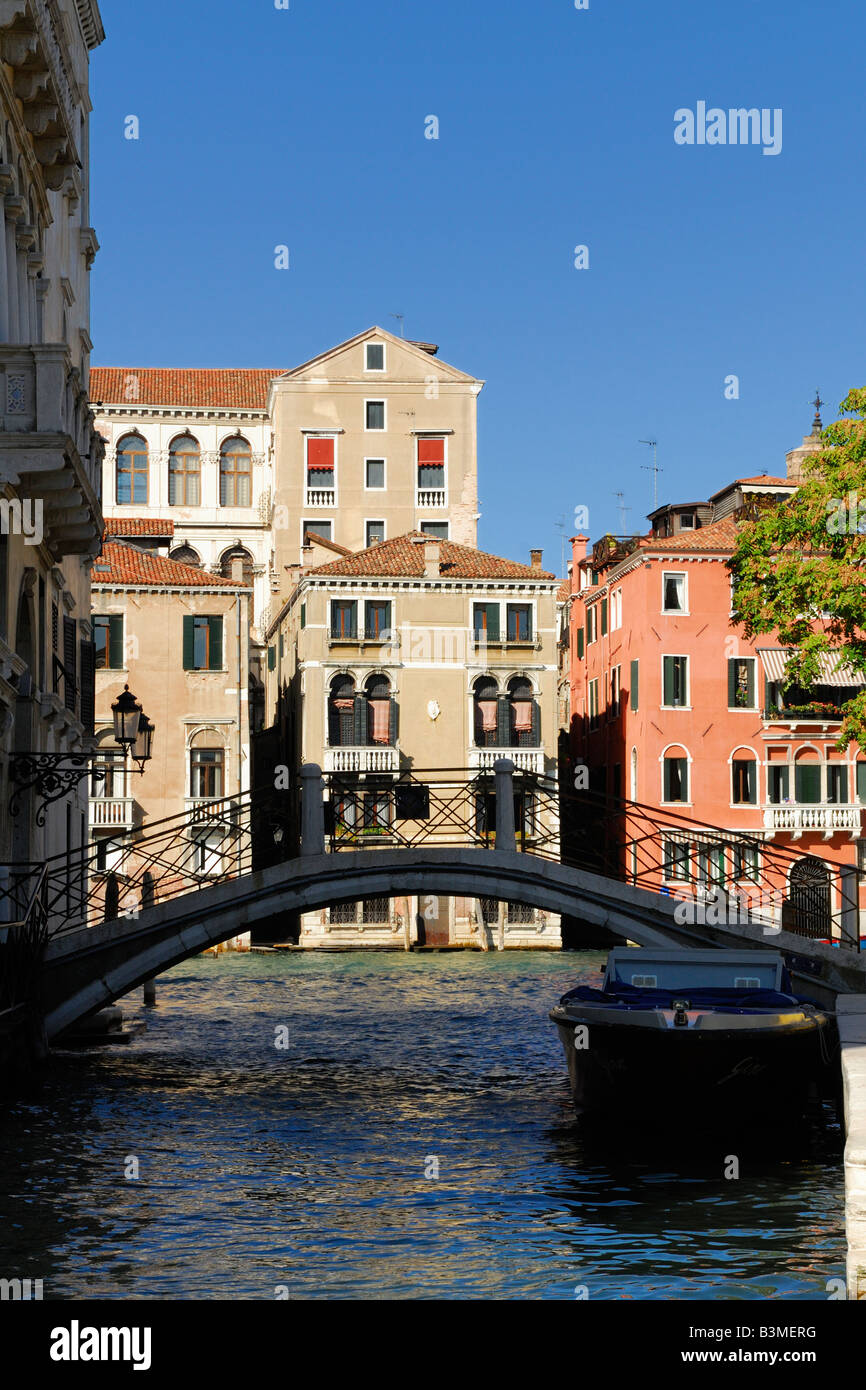 A view of Venice canal showing a bridge, venetian buildings, and a ...
