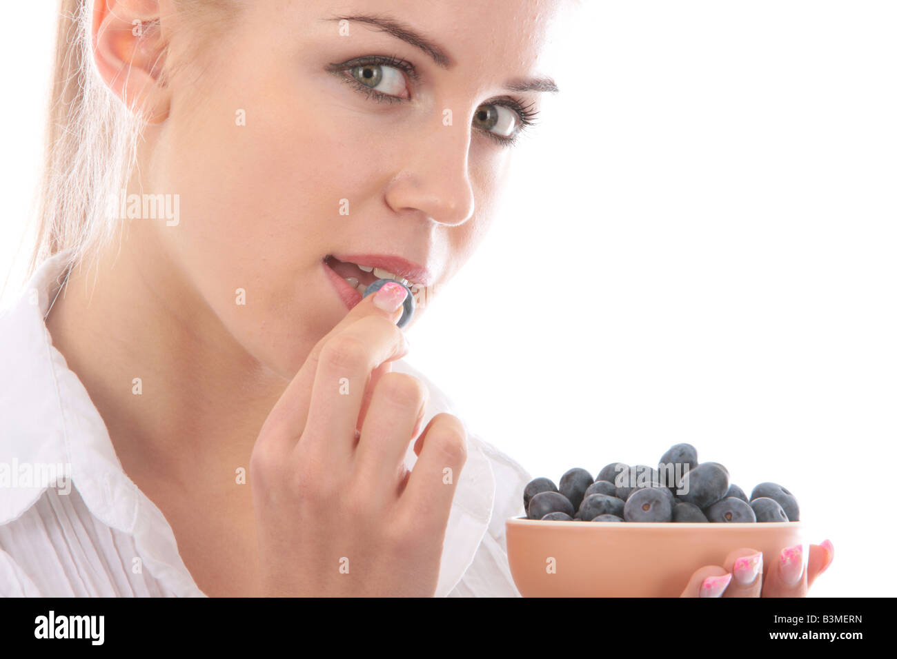 Young Woman Eating Blueberries Model Released Stock Photo - Alamy