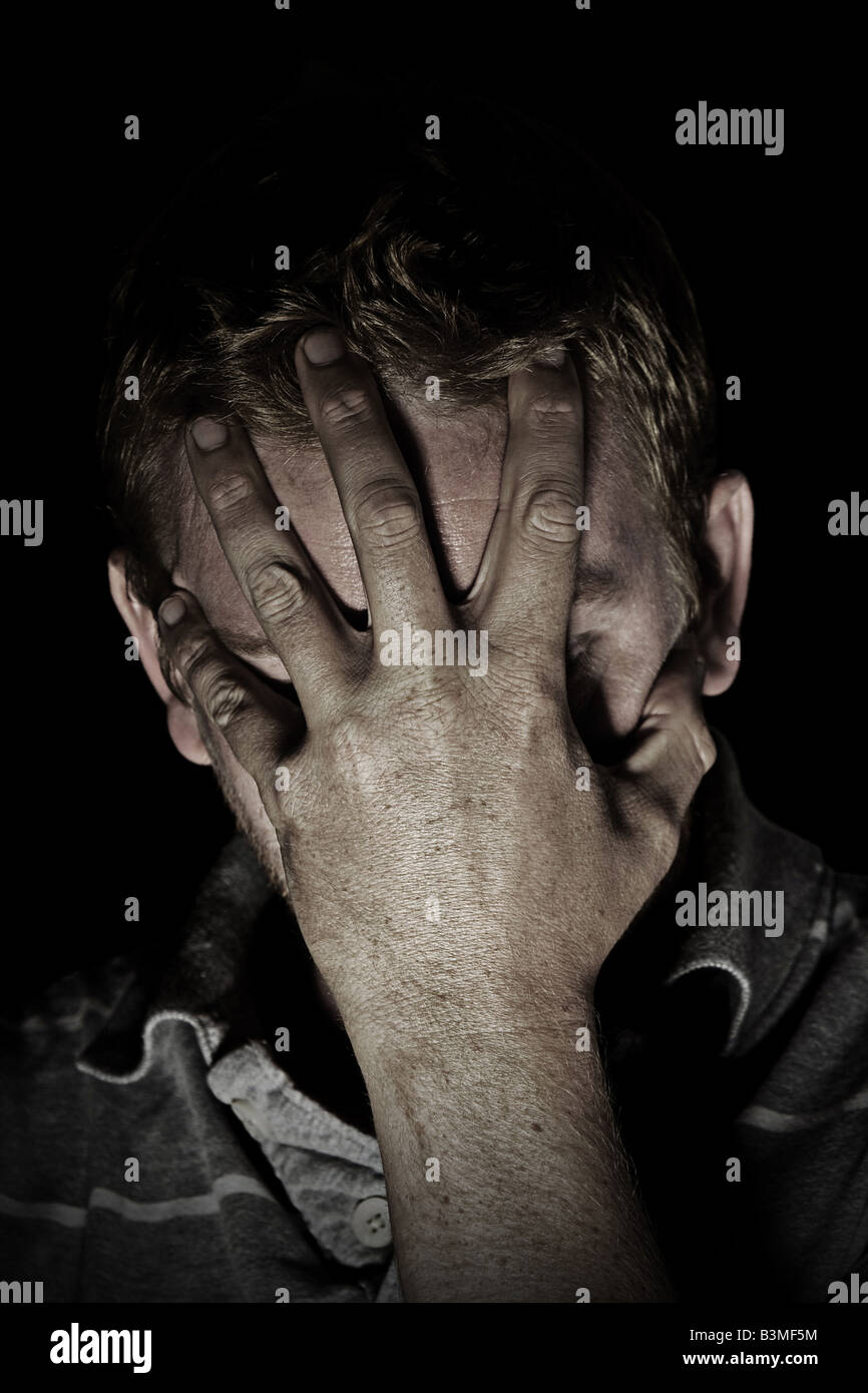 Depressed Male with Head in his Hand Stock Photo - Alamy