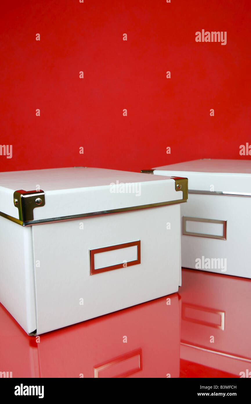 Storage boxes isolated against a red background Stock Photo - Alamy