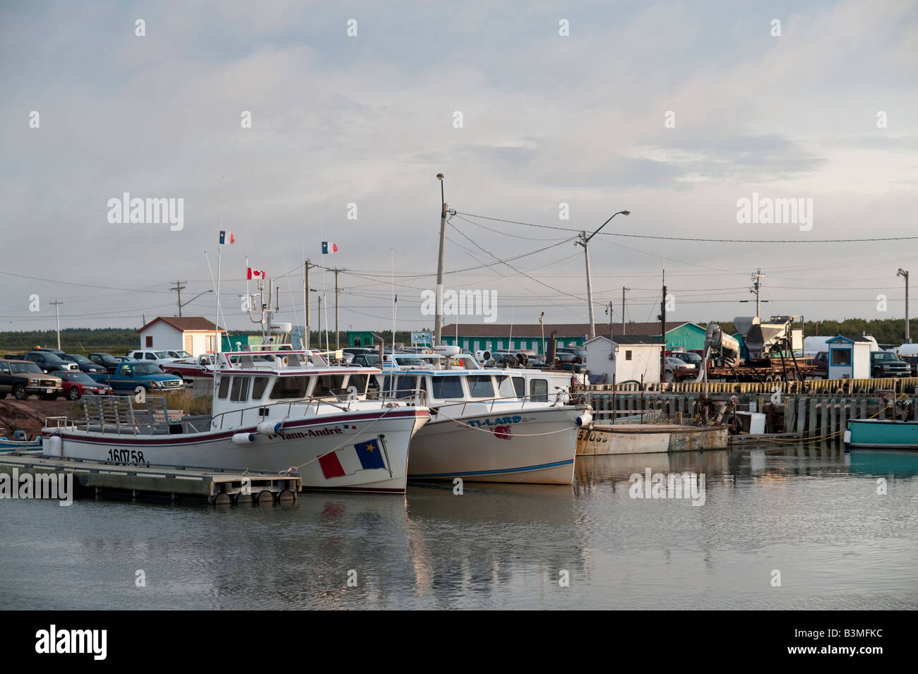 Acadien fishing boats at Pigeon Hill wharf on Lameque Island, New ...