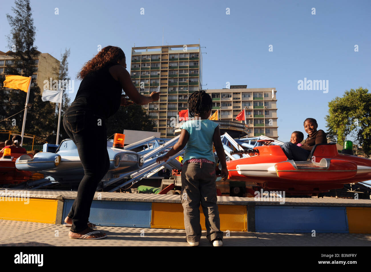 Enjoying rides on the fairground attractions at Feira Popular, Maputo ...
