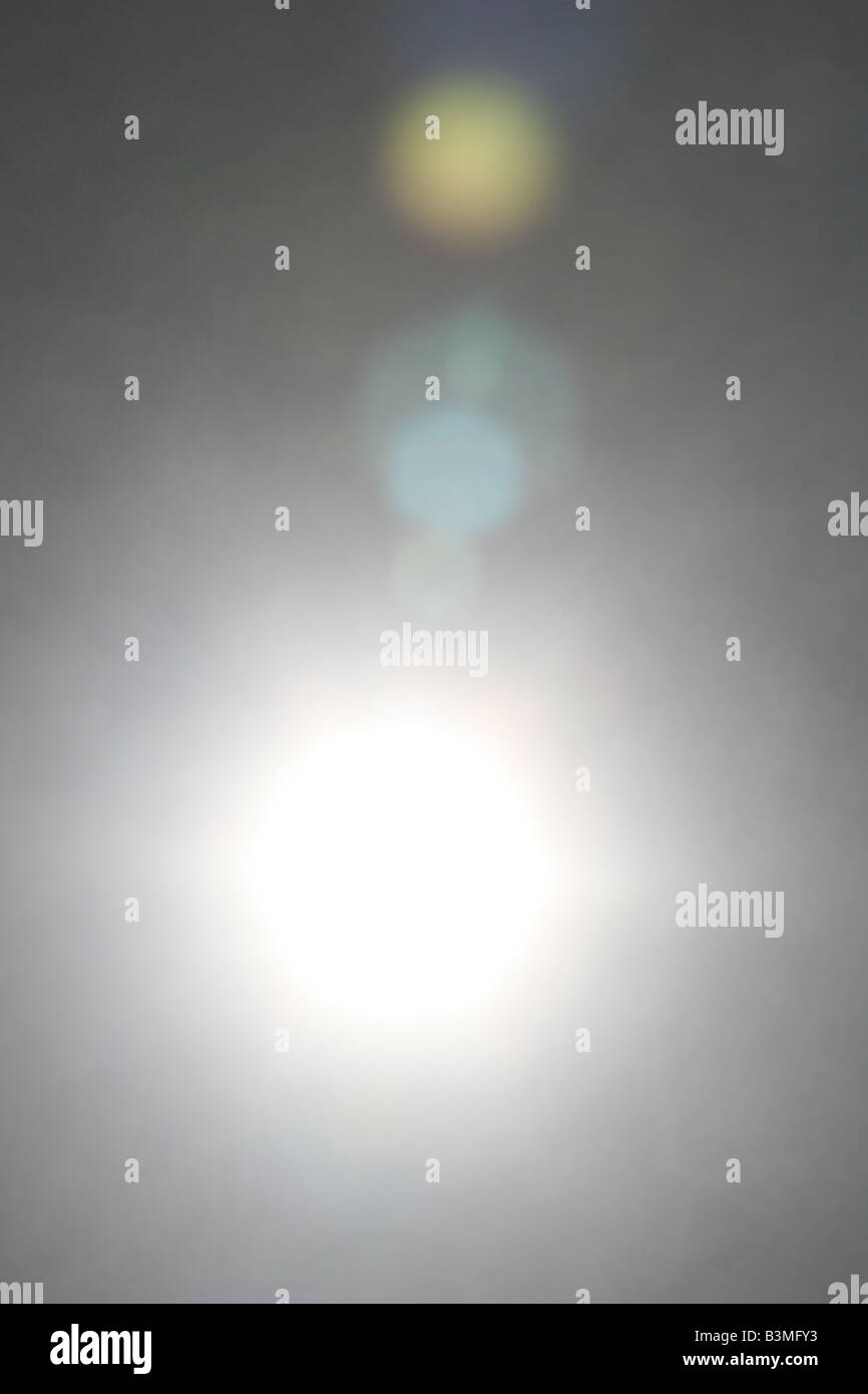 Lens flare looking in the sun, with a partial spectrum of colors ...