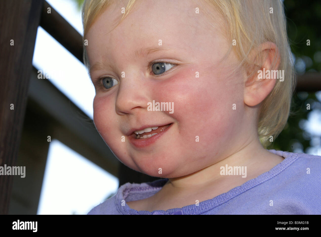 female child with gleeful look anticipating going down a slide Stock ...