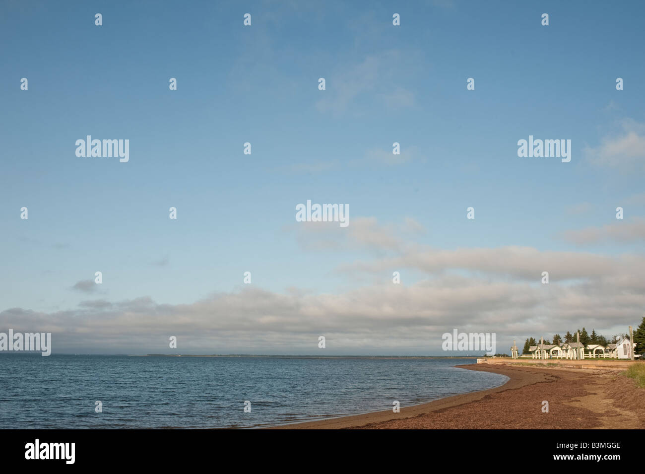 A long deserted seaweed strewn beach on Lameque Island New Brunswick ...