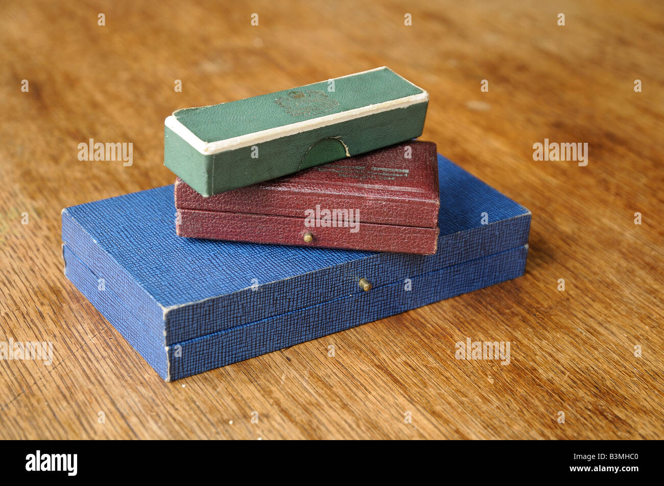 A pile of old fashioned boxes on a wooden table Stock Photo - Alamy