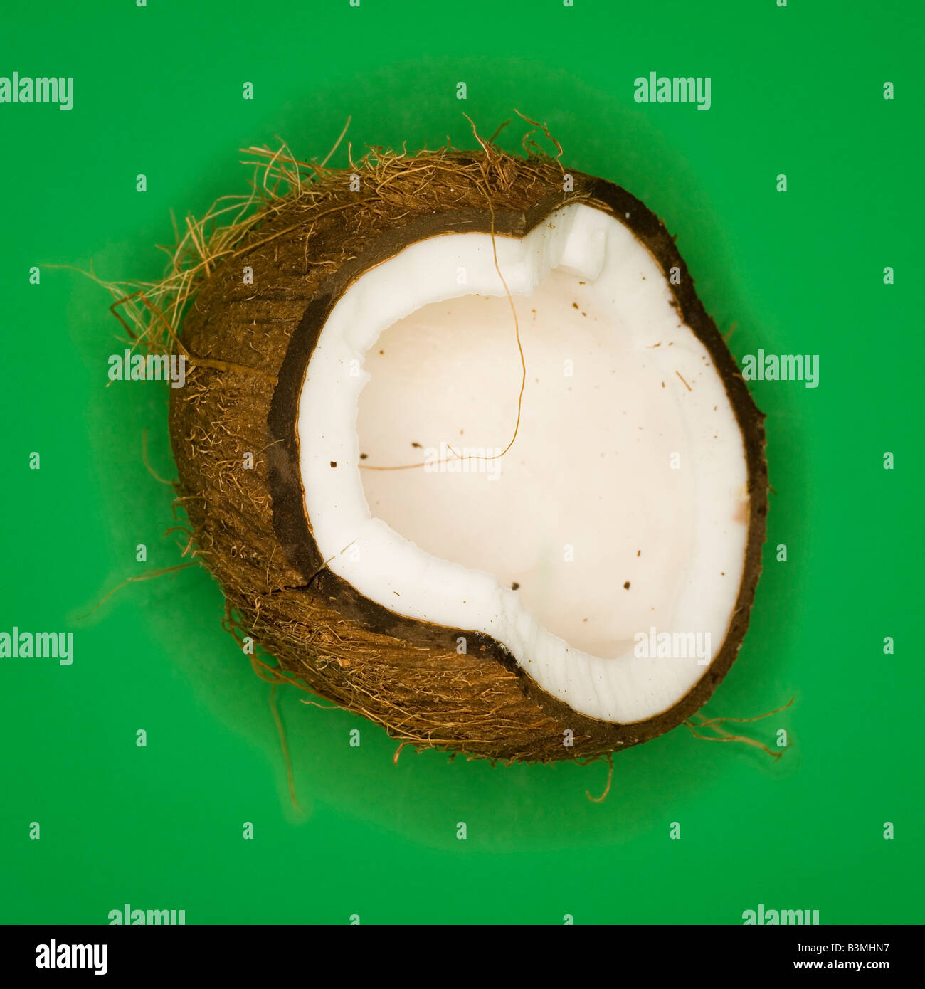 Coconut split in half, elevated view Stock Photo - Alamy