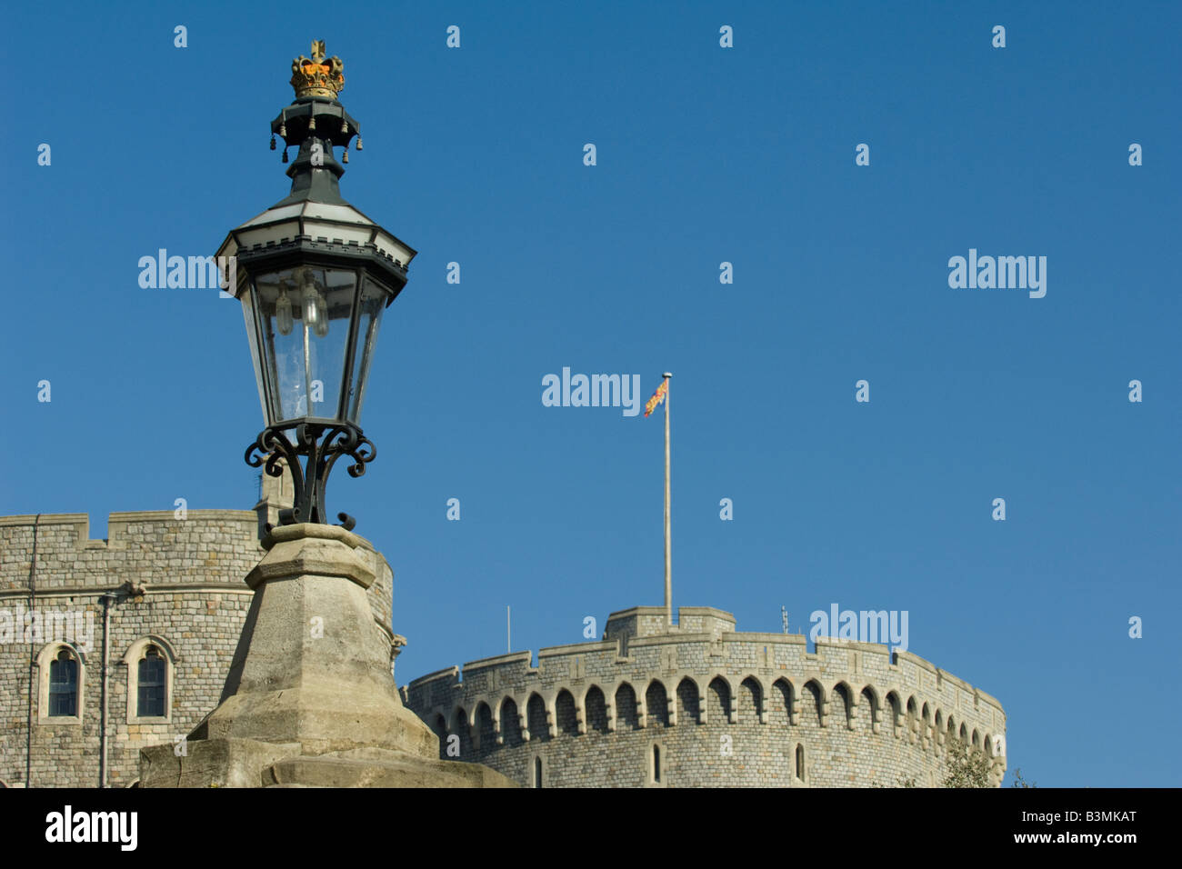 Royal Standard flag flying above Windsor Castle main tower, and old gas ...