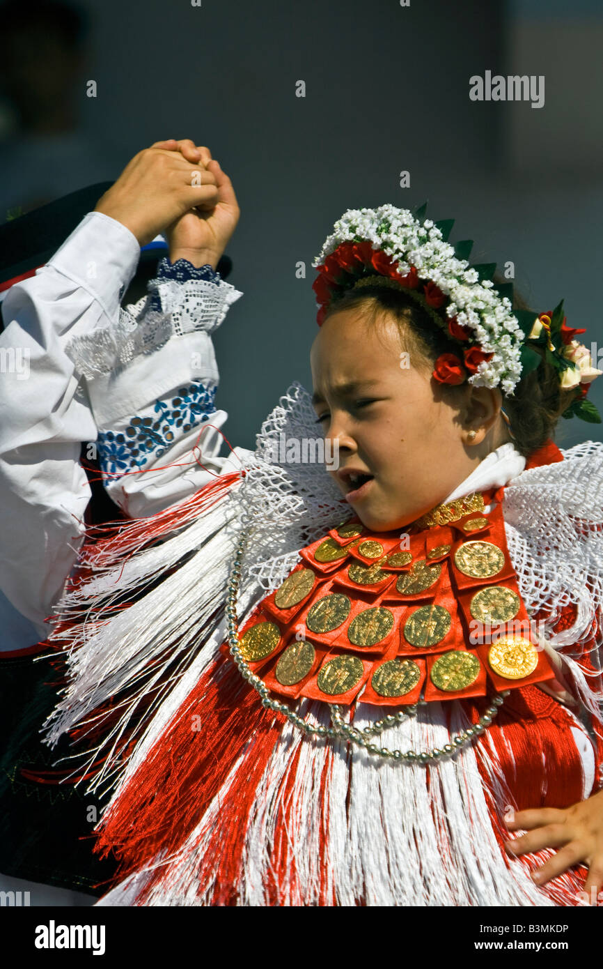 Young girl dancing and singing in the Croatian traditional dress with ...