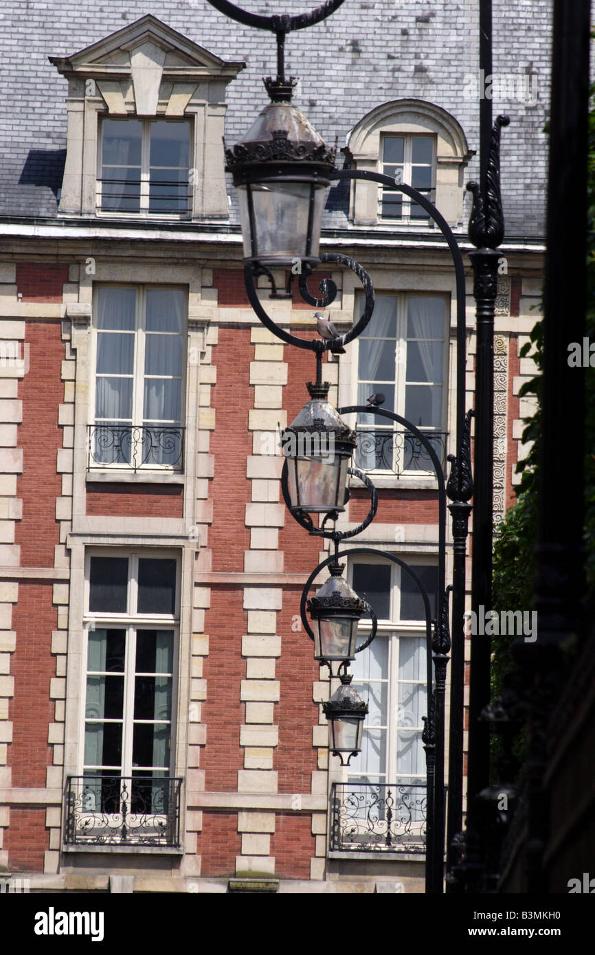 France Paris Street lights and town houses in Place des Vosges in Paris ...