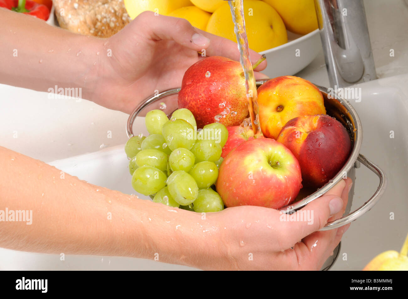 MAN WASHING FRESH FRUIT IN COLLANDER Stock Photo - Alamy