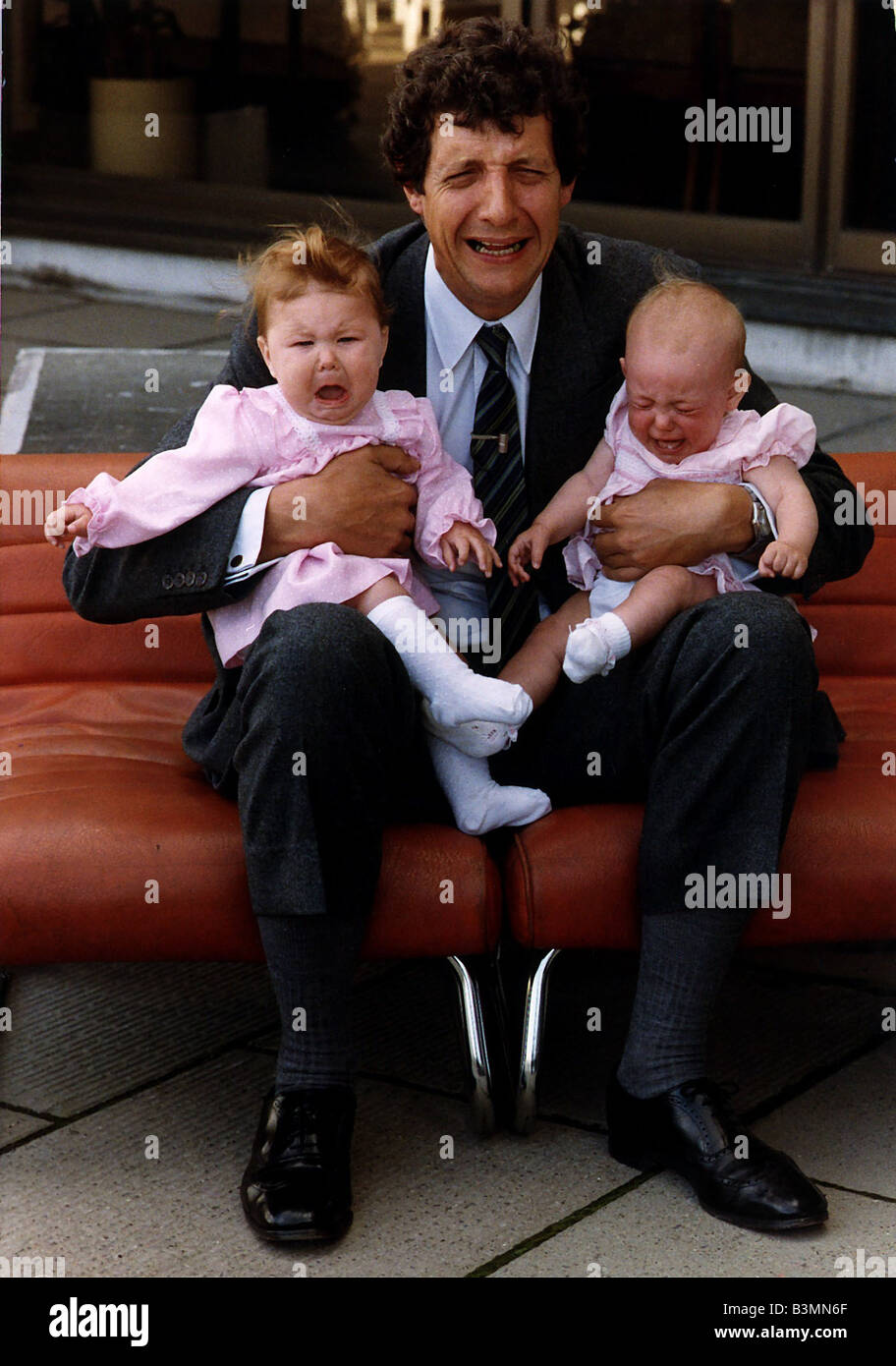 Chris Serle TV Presenter with two babies Stock Photo - Alamy